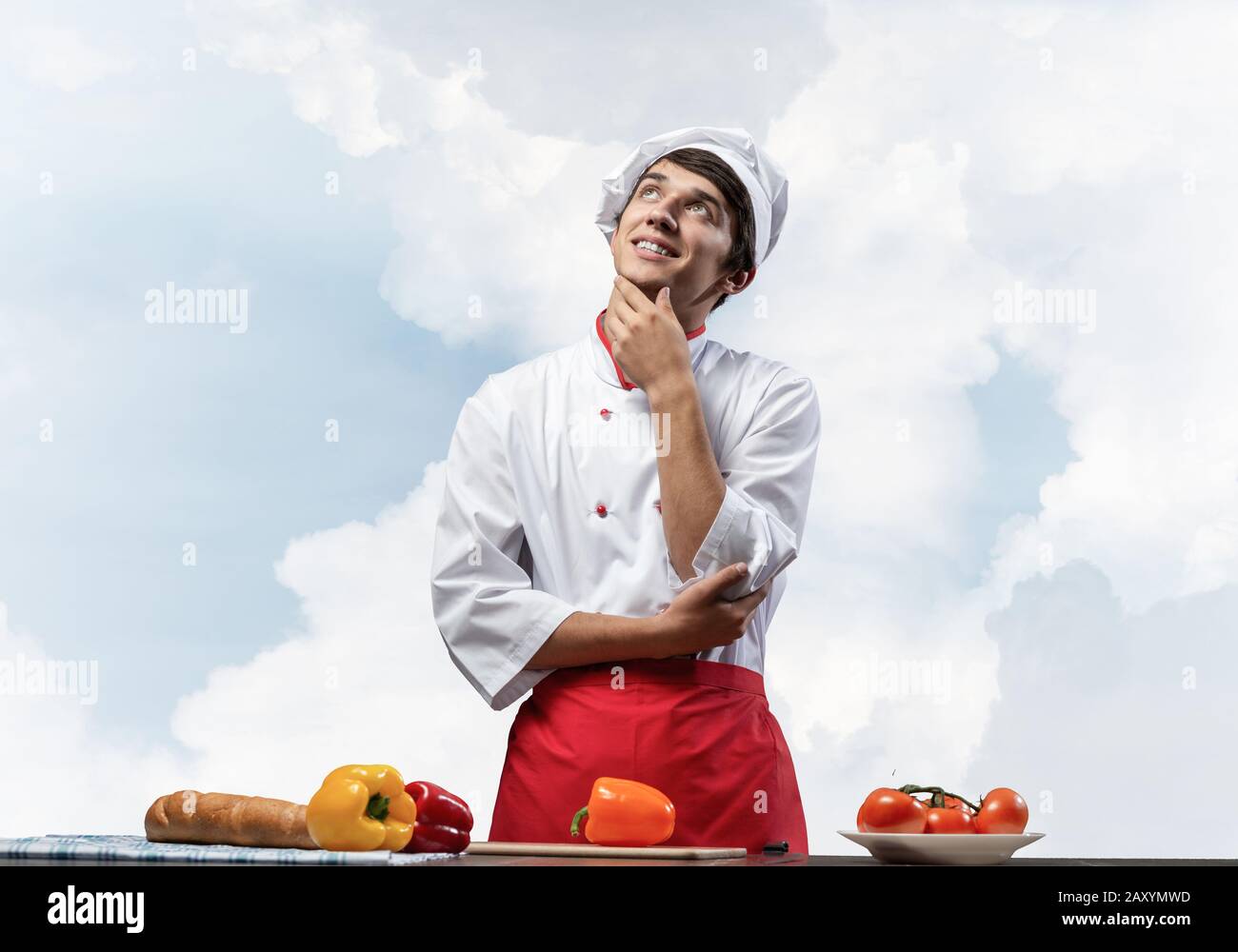 Young male chef standing with folded arms Stock Photo - Alamy