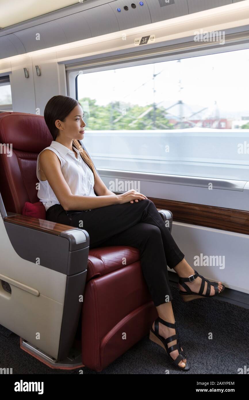 Business class in train. Asian lady enjoying view in train commute ...