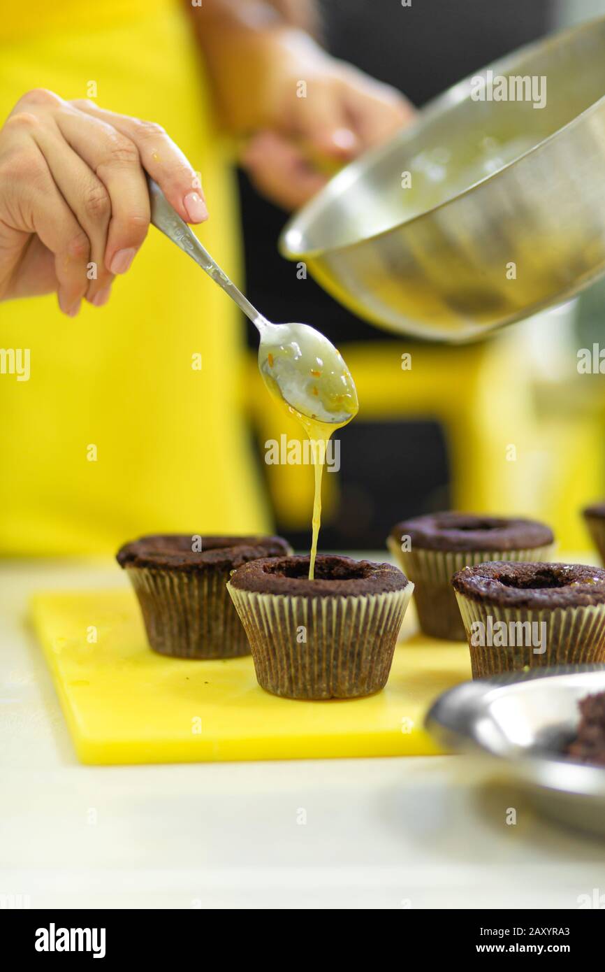 The process of making chocolate cupcakes with sweet cream. Creation of ...