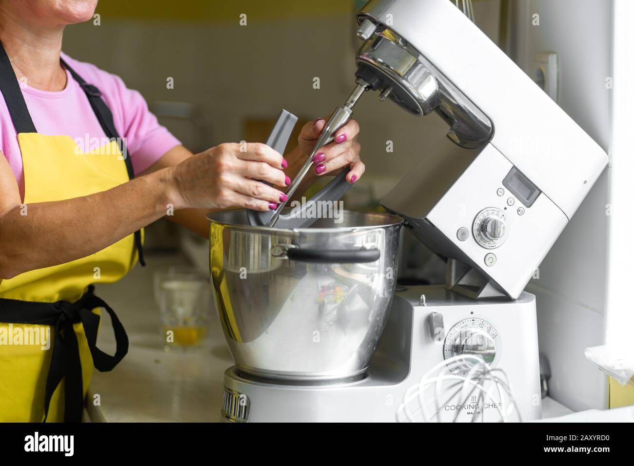 Woman professional pastry chef preparing a dessert. Adds ingredients ...