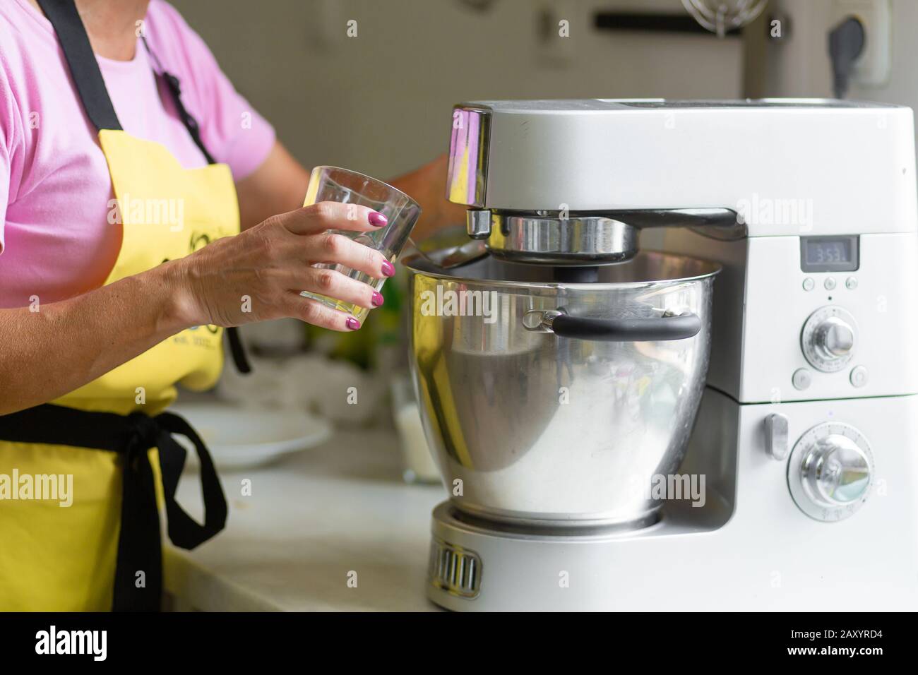Woman professional pastry chef preparing a dessert. Adds ingredients ...