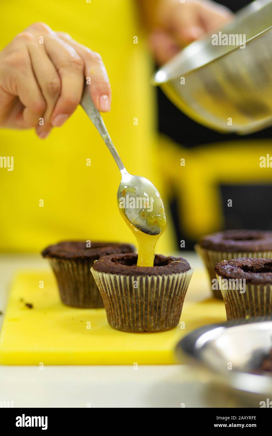 The process of making chocolate cupcakes with sweet cream. Creation of ...