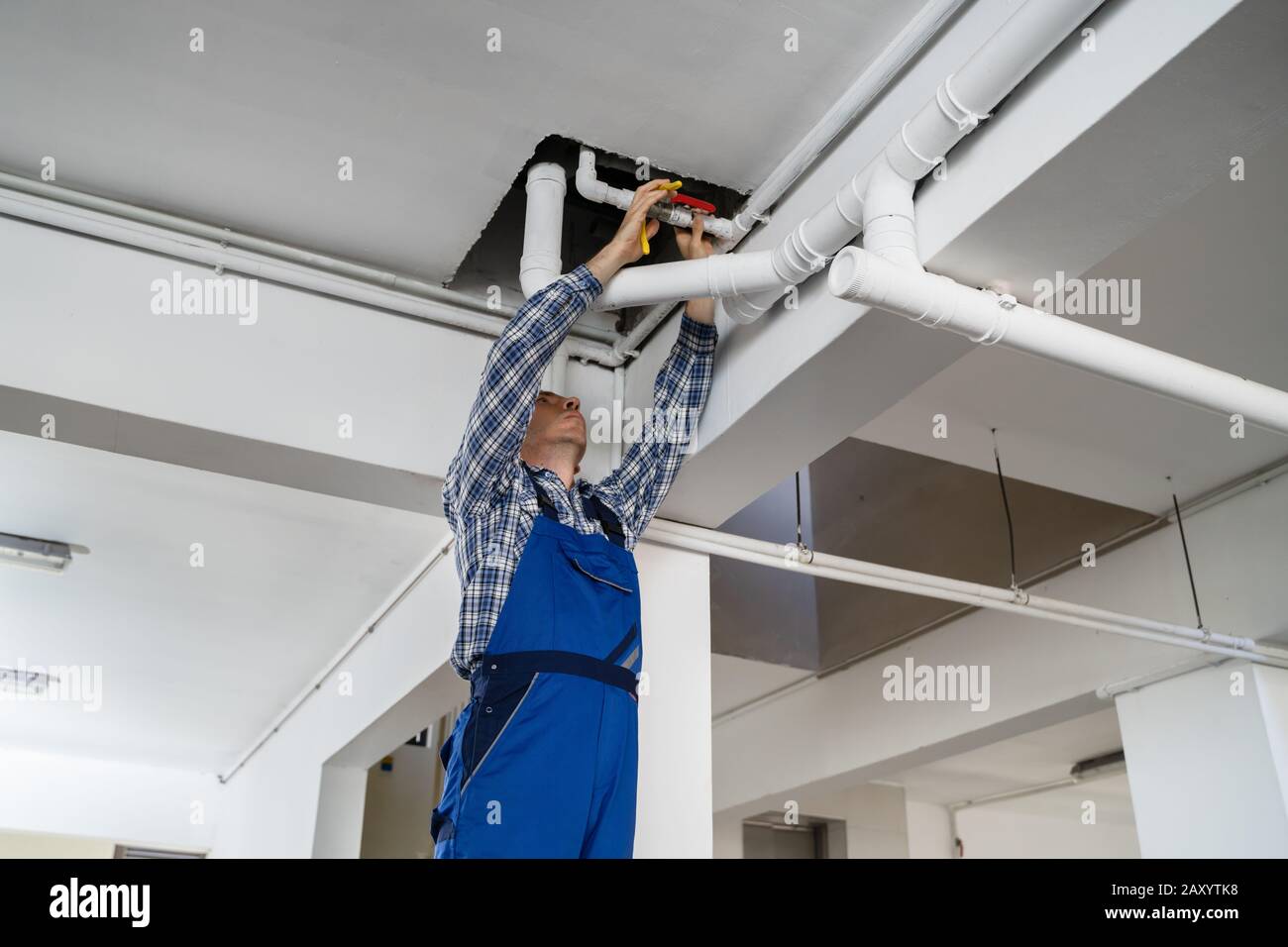 Plumber Repairing Water Pipes In Residential Building Stock Photo - Alamy
