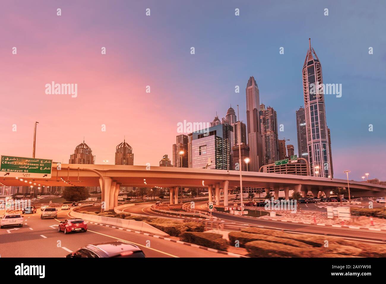 27 November 2019, UAE, Dubai: High speed highway road at sunset among ...