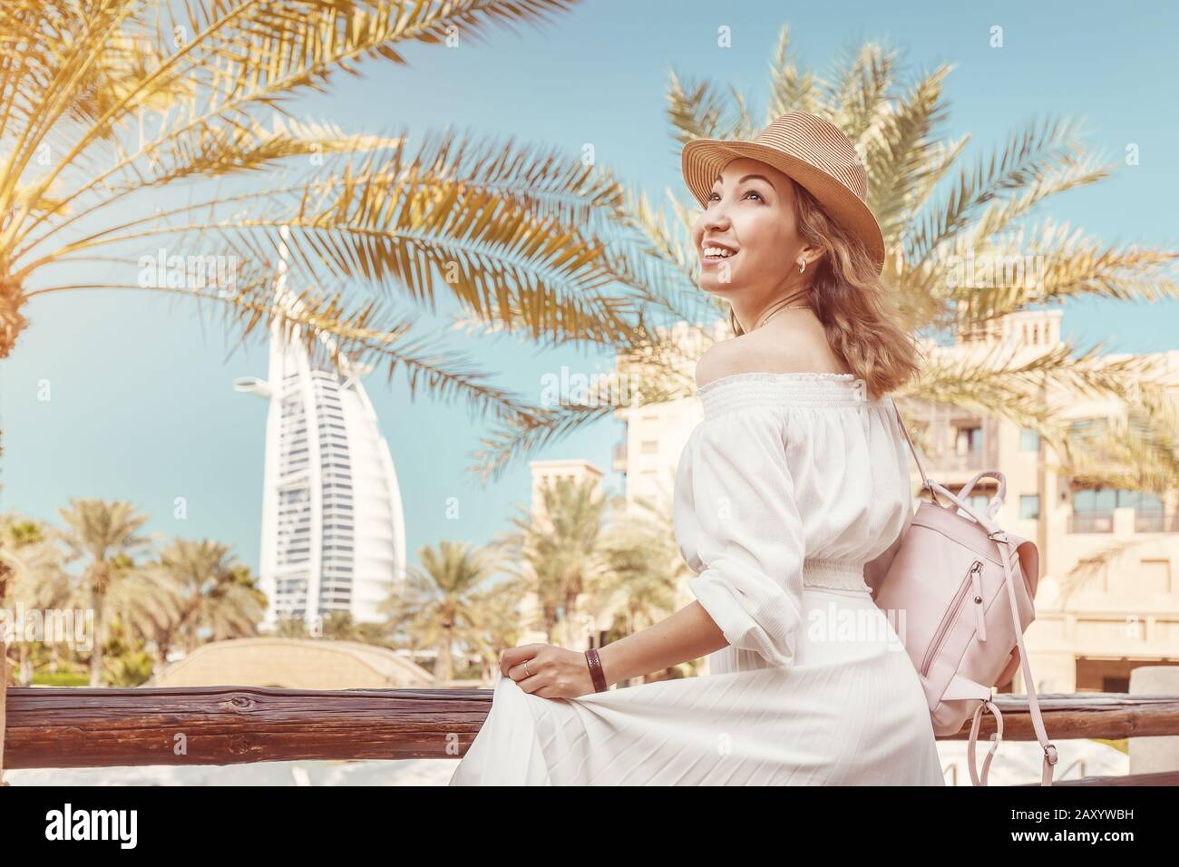 Cheerful Asian tourist girl with the famous Burj al Arab hotel building ...