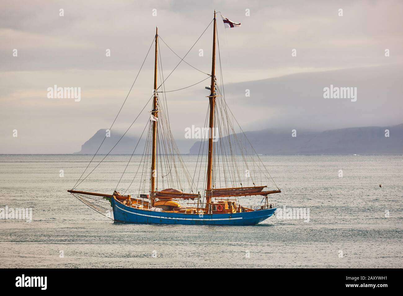 Yacht sailing on Faroe island fjords. Atlantic ocean coastline ...