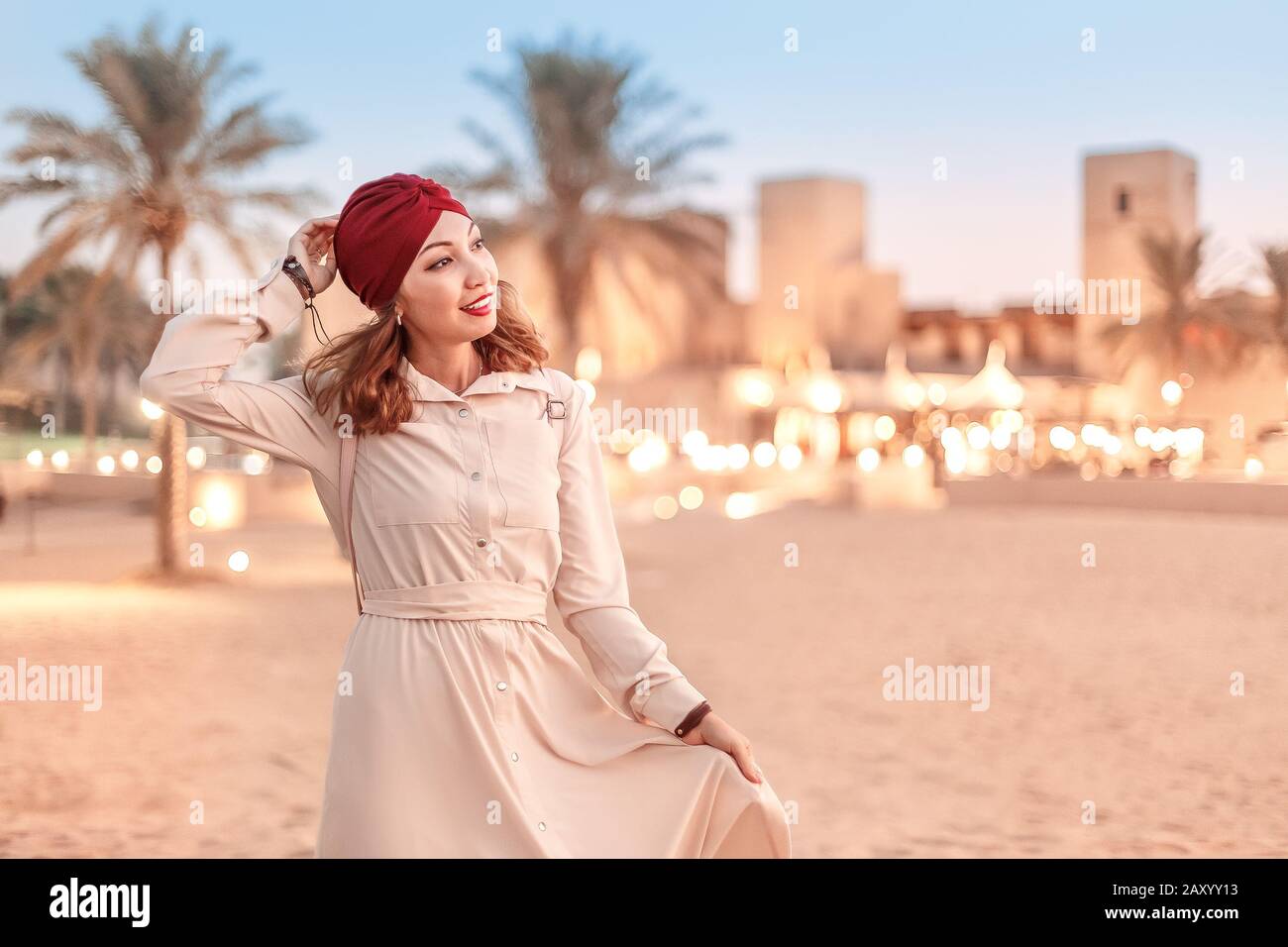 Happy asian woman in turban travels in Sahara desert. Oasis and Bedouin ...