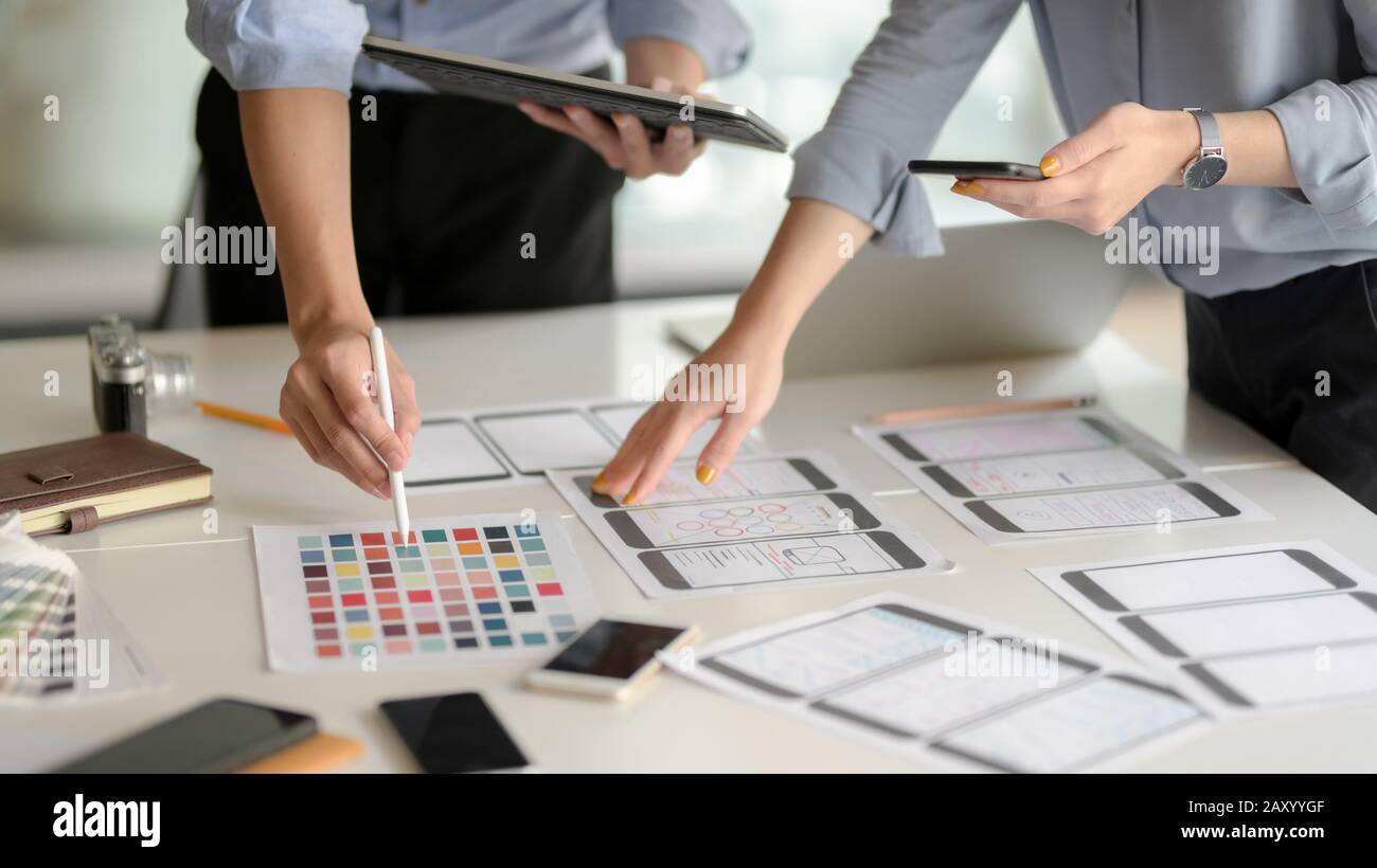 Close up view of professional UI developer team brainstorming on their ...
