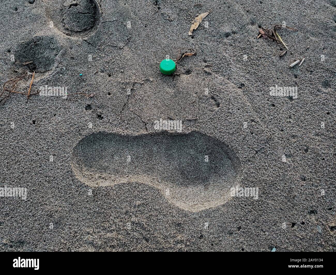 Plastic bottle cork and human footprint on sandy sea ecosystem ...