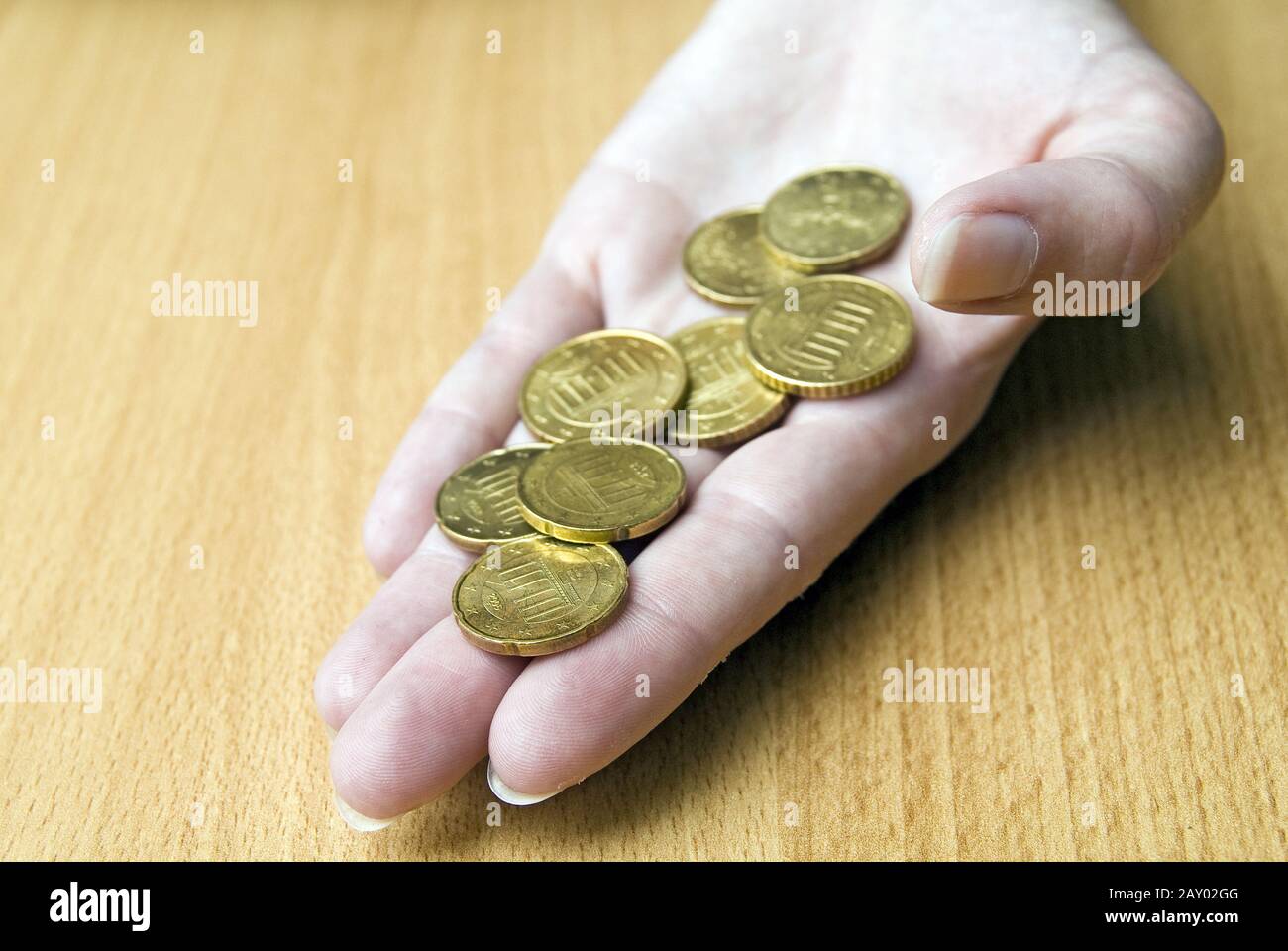 Hand with change Stock Photo - Alamy
