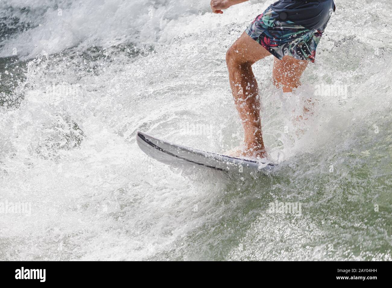 Close up on the legs of an athlete surfing on the sea waves Stock Photo ...
