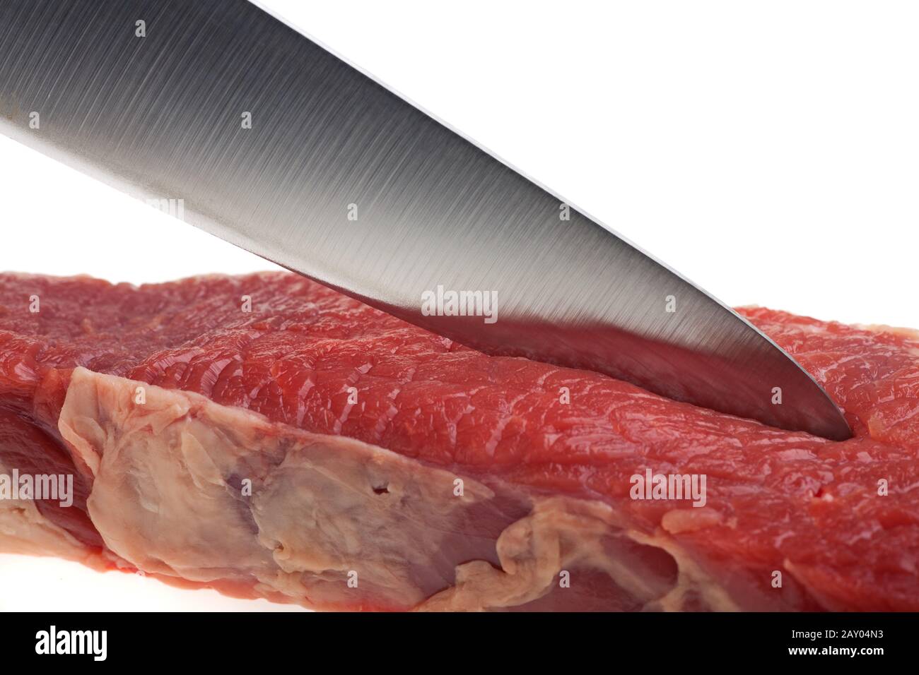 Kitchen knife cuts through a raw steak Stock Photo - Alamy