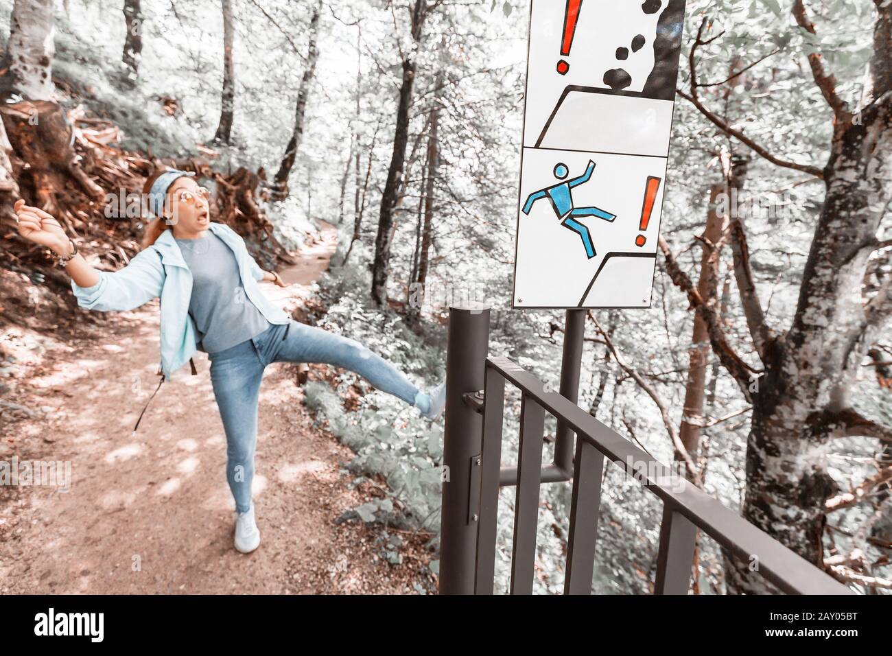 Funny girl slipped on the slippery slope of a Hiking trail in the ...