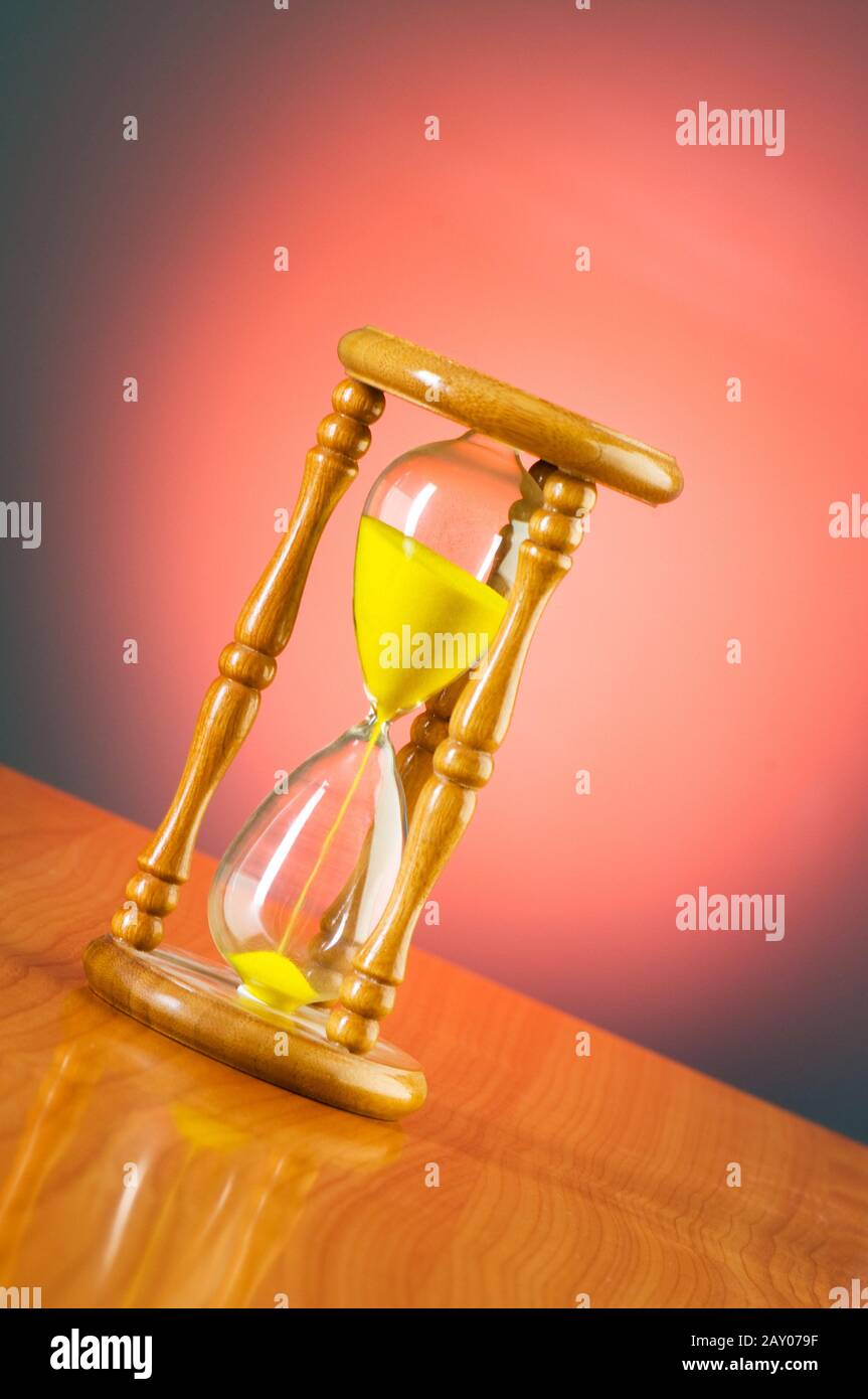 Time concept with hourglass against background Stock Photo - Alamy