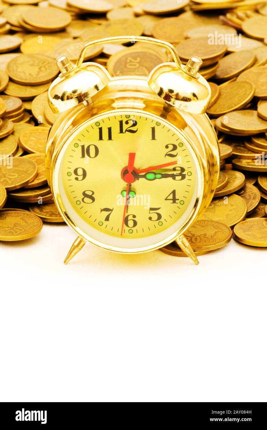 Time is money concept with clock and coins Stock Photo - Alamy