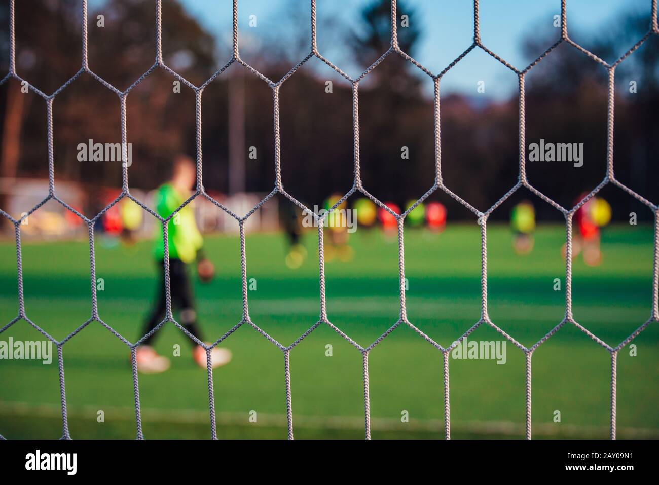Soccer net, football match in background, green colors, sunrise natural ...