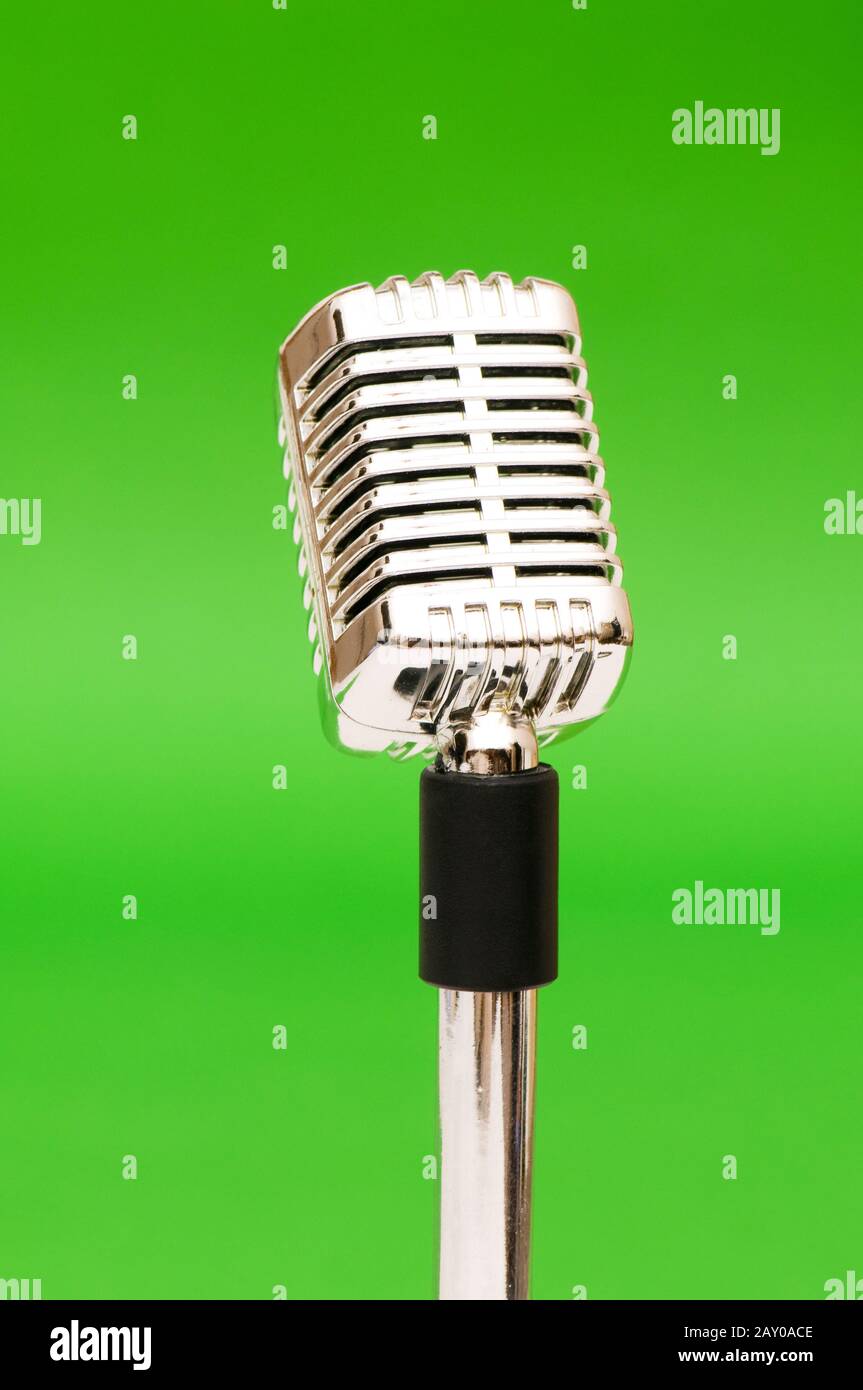 Vintage microphone against the bright green background Stock Photo - Alamy