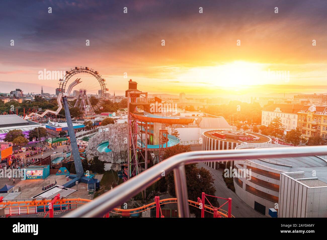 Aerial view of amusement park at sunset with ferris wheel and roller ...