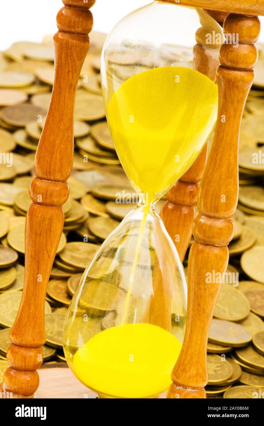Time is money concept - hourglass and coins Stock Photo - Alamy