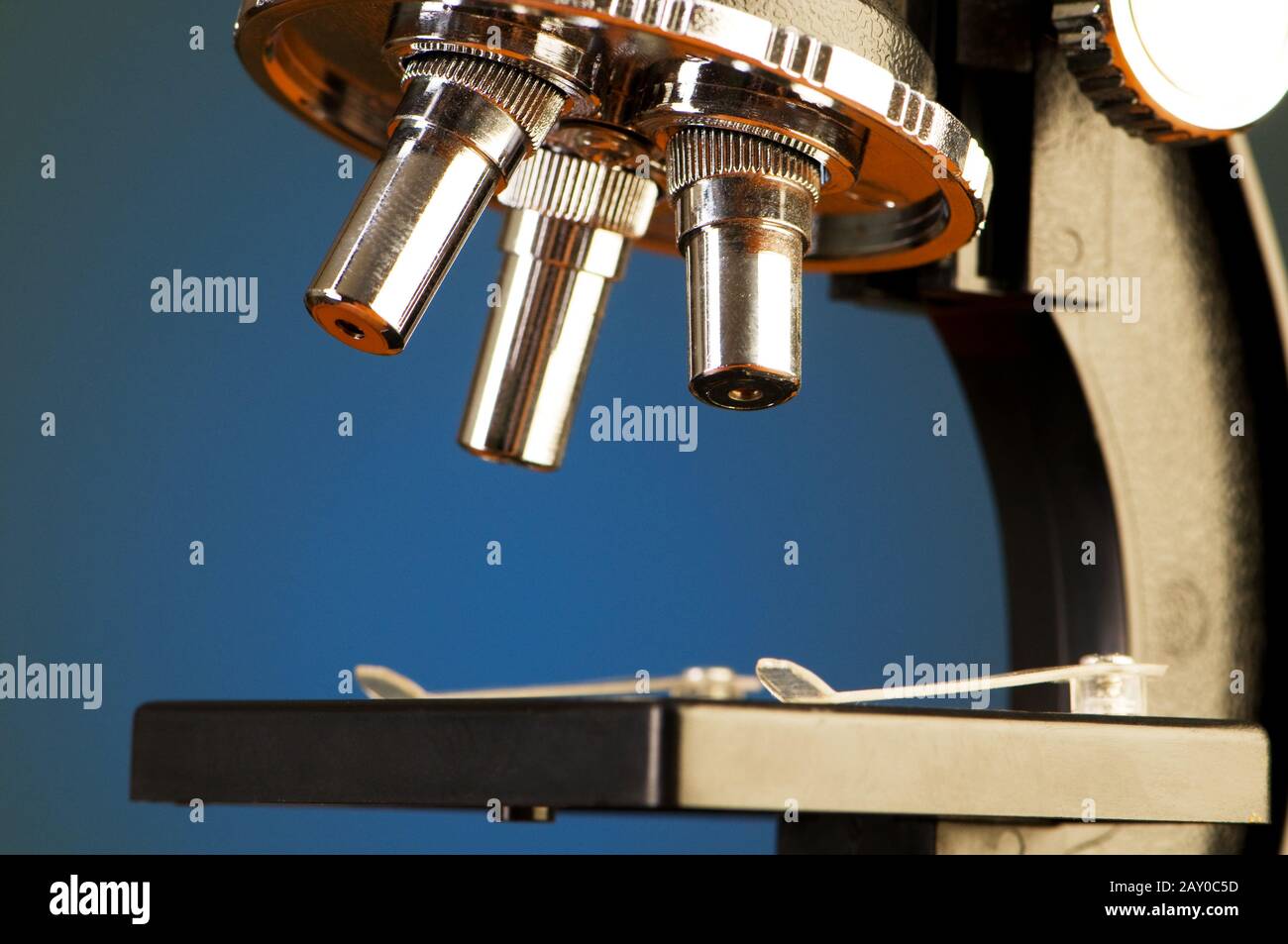 Microscope against blue gradient background Stock Photo - Alamy