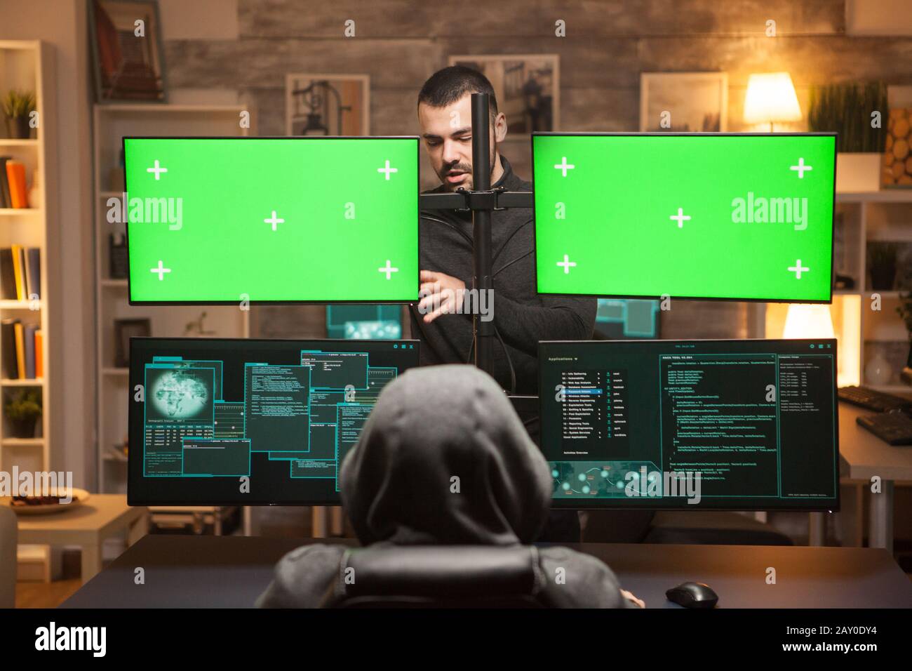 Back view team of hackers doying cyber attacks in front of computer ...