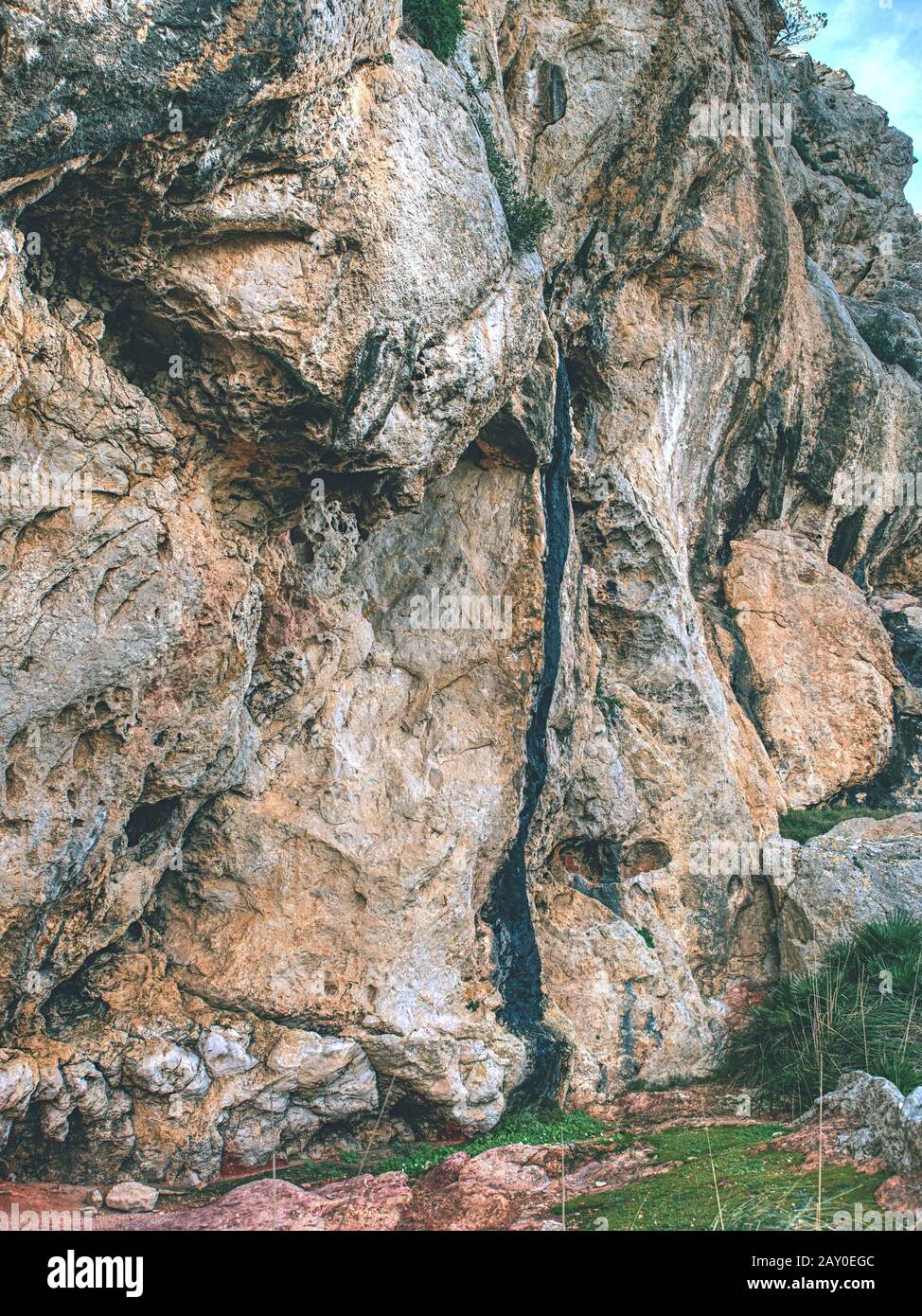 Sharp cracked and broken mountain wall detail. Stone surface covered ...