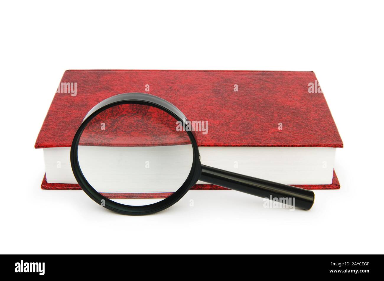Magnifying glass over the stack of books Stock Photo - Alamy