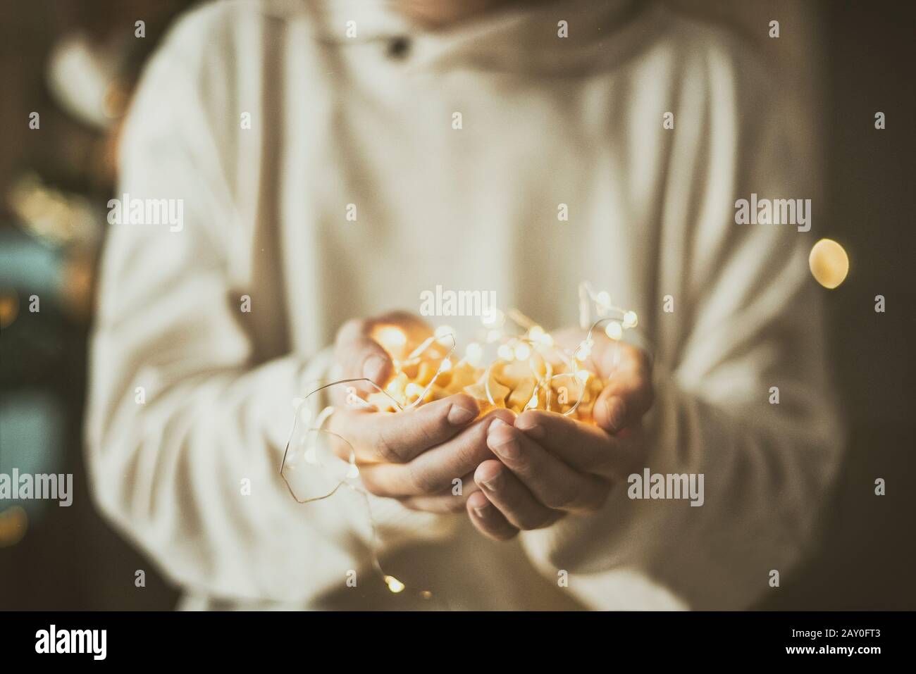Boy holding Christmas string lights in his hand Stock Photo - Alamy