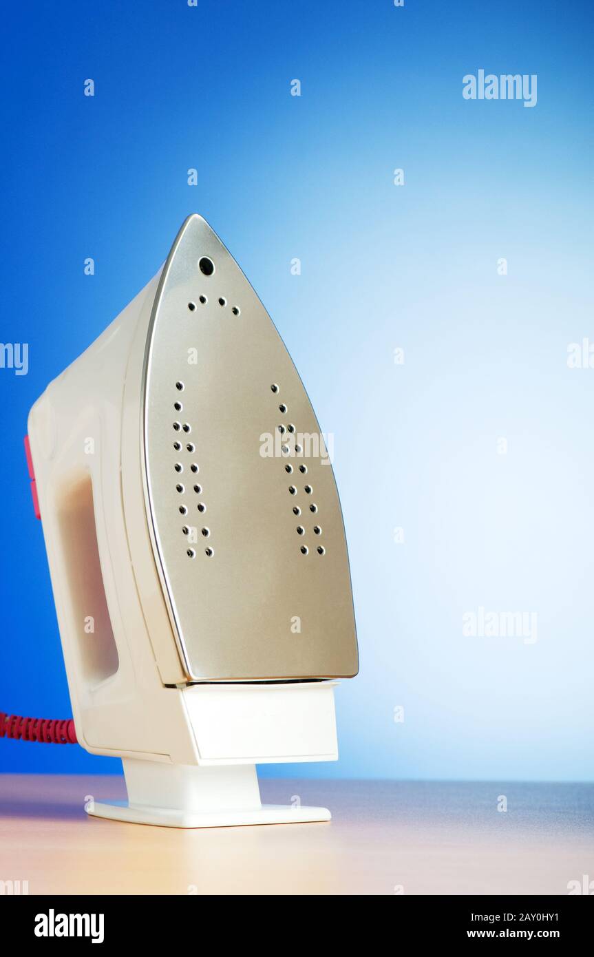 Modern electric iron against the colorful background Stock Photo - Alamy