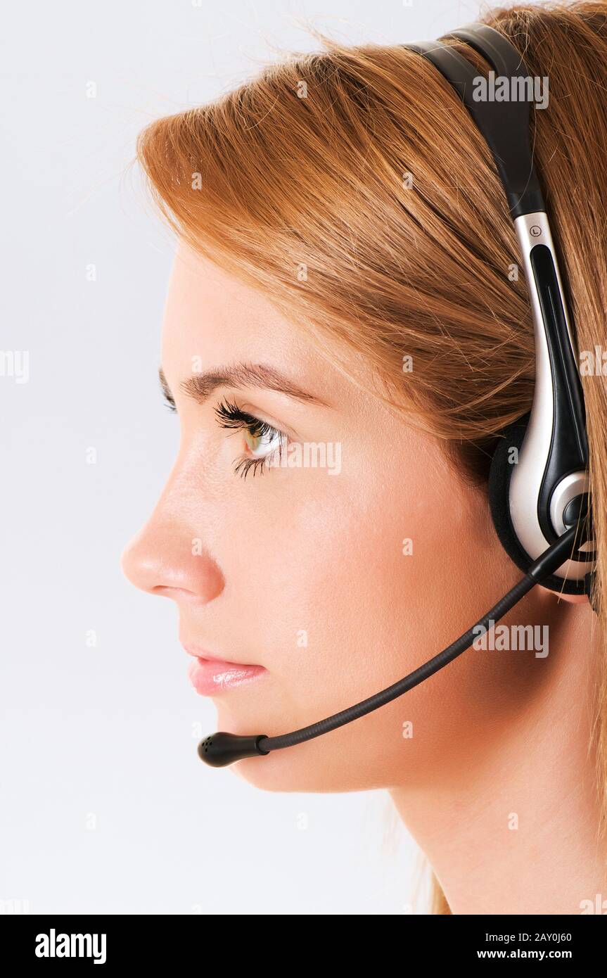 Young call center operator with the headset Stock Photo - Alamy