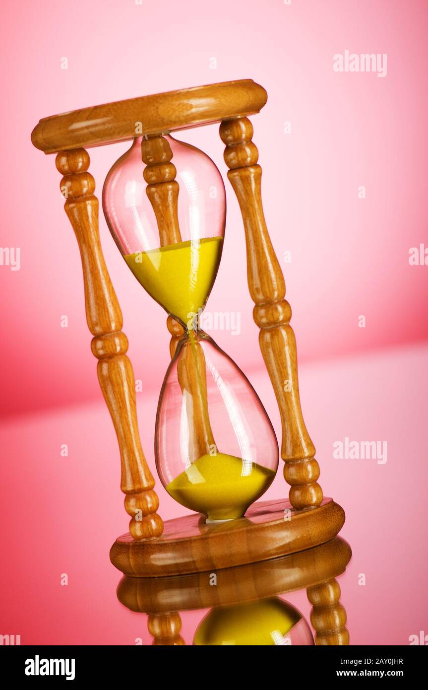 Time concept - hourglass against the gradient background Stock Photo ...