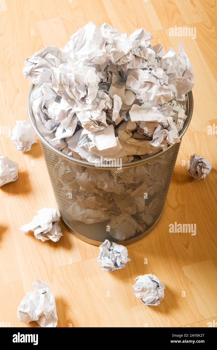 Garbage bin with paper waste isolated on white Stock Photo - Alamy