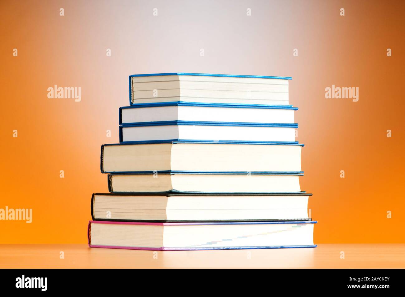 Stack of text books against gradient background Stock Photo - Alamy