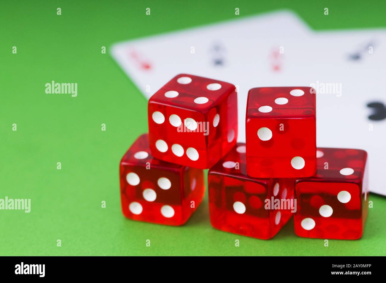 Red dice and cards at the green background Stock Photo - Alamy