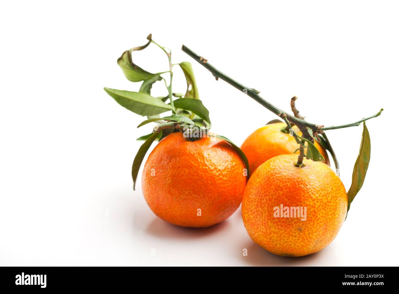 three mandarins on a white background Stock Photo - Alamy