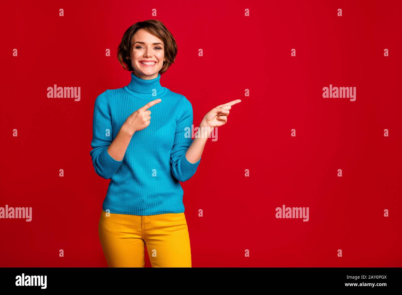 Portrait of positive cheerful girl promoter point index finger copy ...