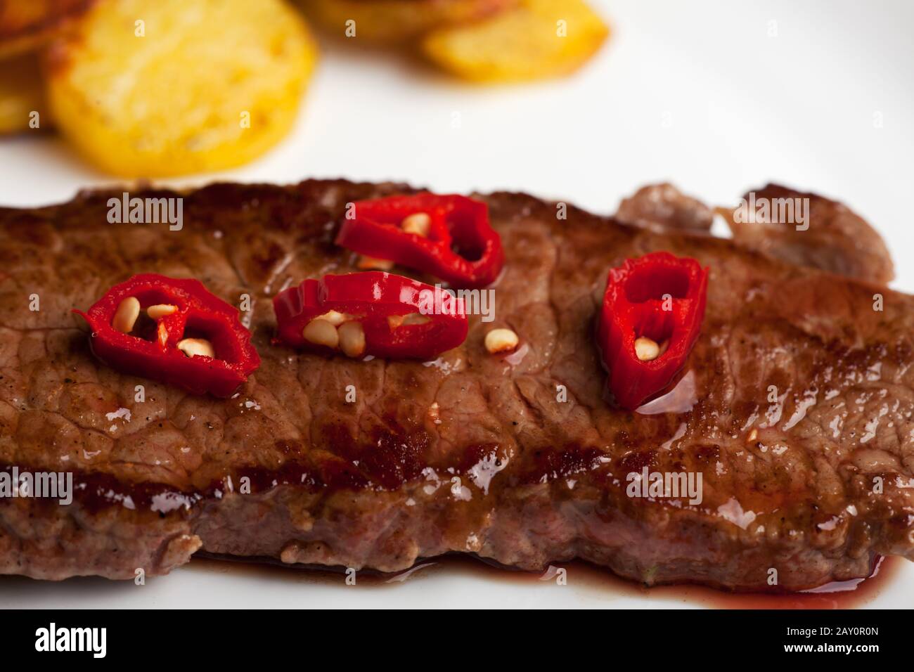 Chilli slices on a steak Stock Photo - Alamy