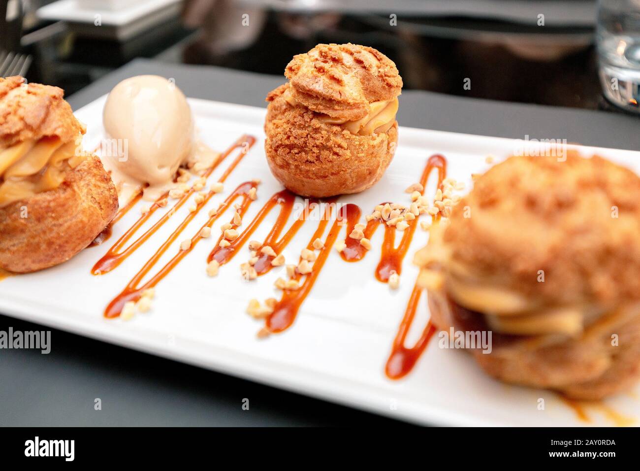 Delicious Profiteroles dessert on a plate in restaurant Stock Photo - Alamy