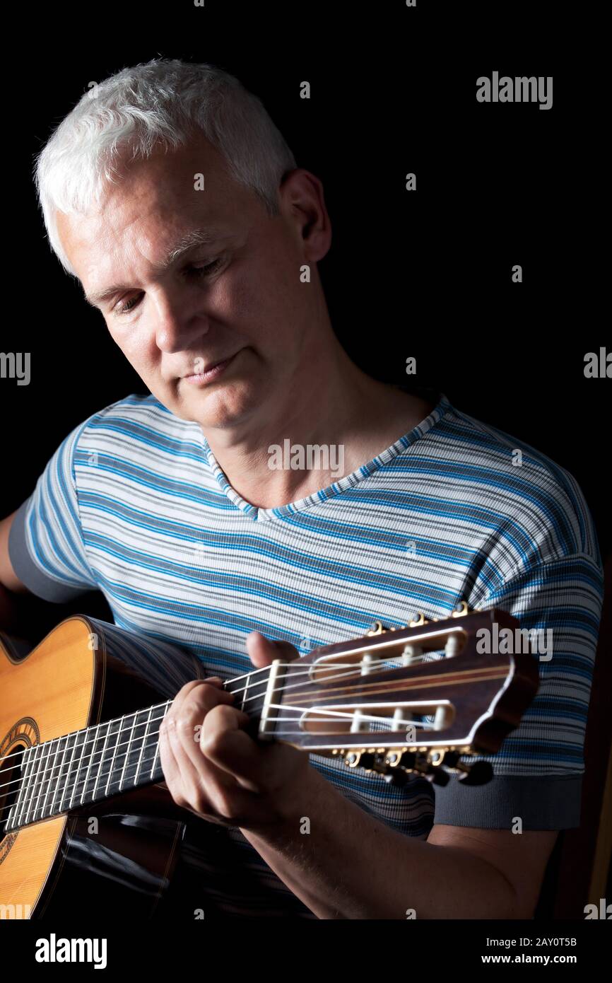 classical guitarist on black Stock Photo - Alamy