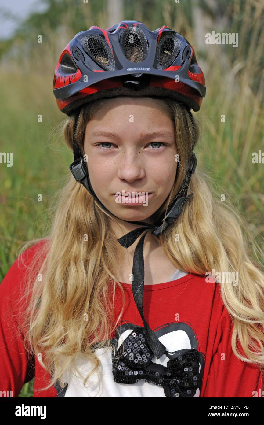 11 year old girl is wearing a crash helmet according to regulations ...