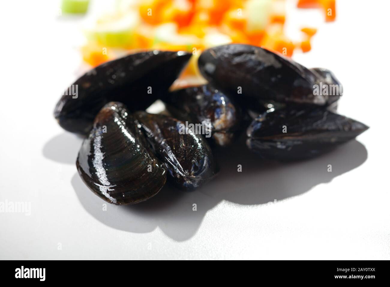 raw mussels and vegetables on white Stock Photo - Alamy