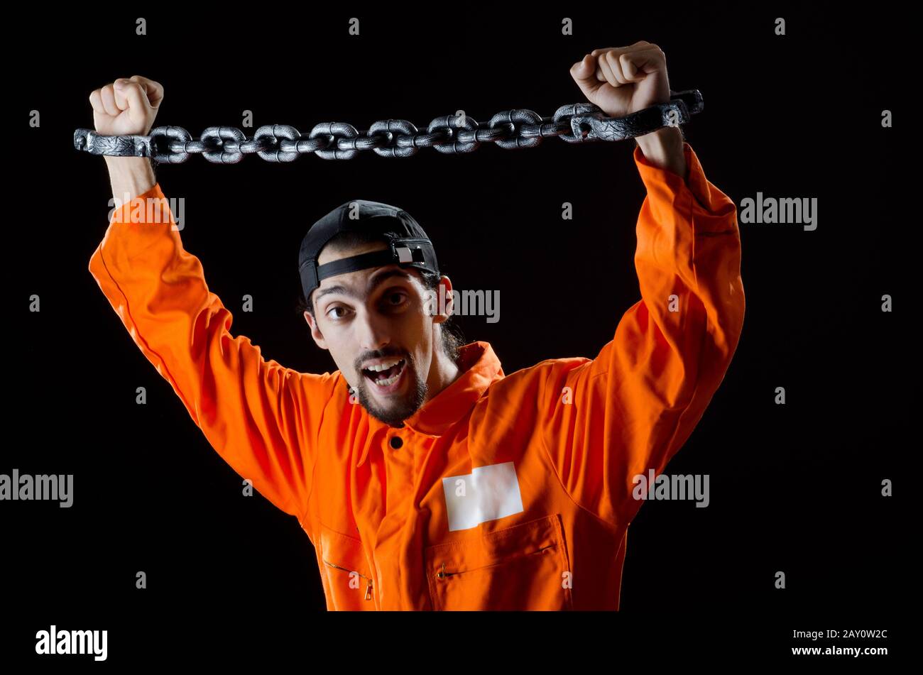 Inmate chained on black background Stock Photo - Alamy