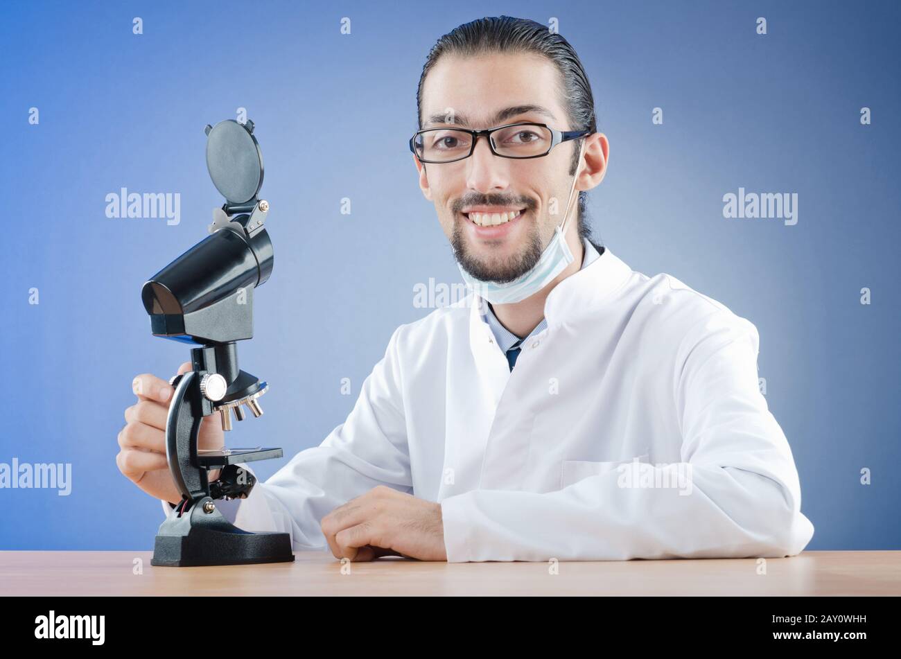 Chemist working with microscope Stock Photo - Alamy