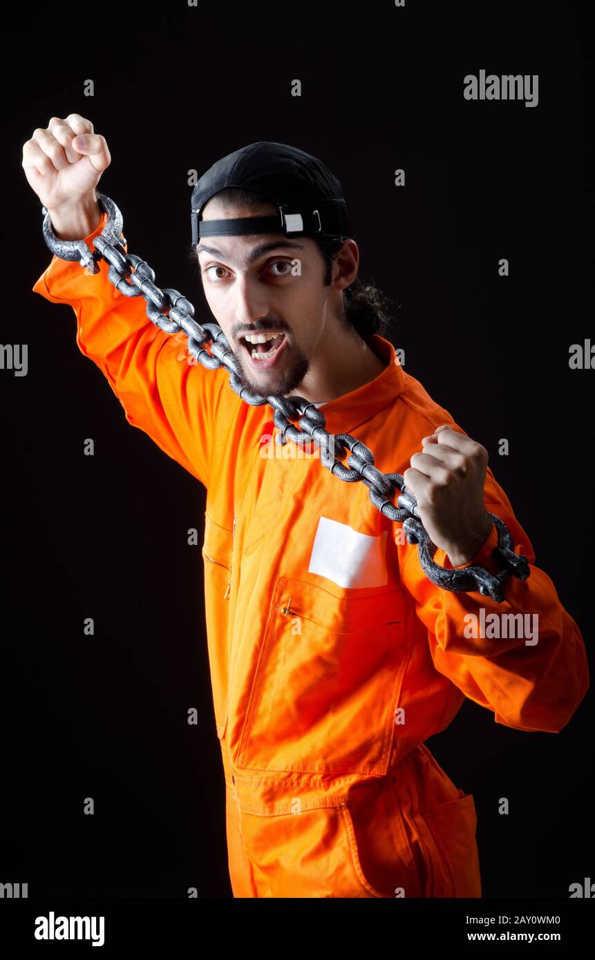 Inmate chained on black background Stock Photo - Alamy