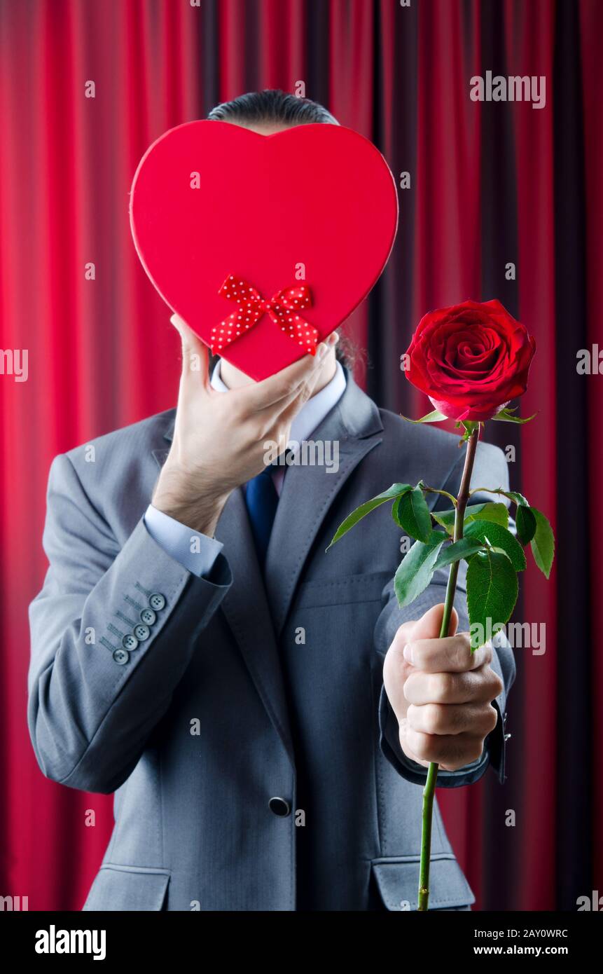 Young man with red rose Stock Photo - Alamy