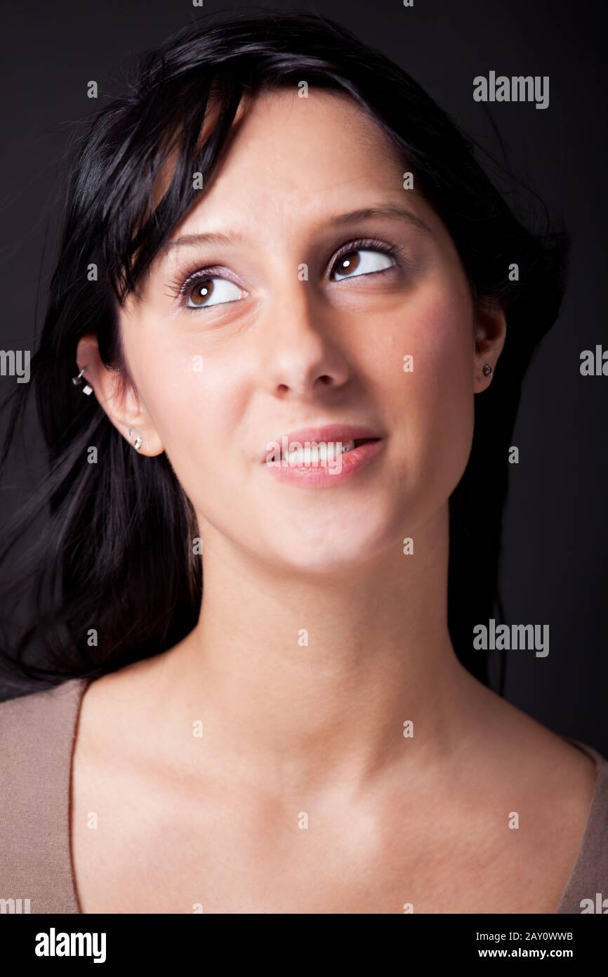 surprised woman looks to the left Stock Photo - Alamy