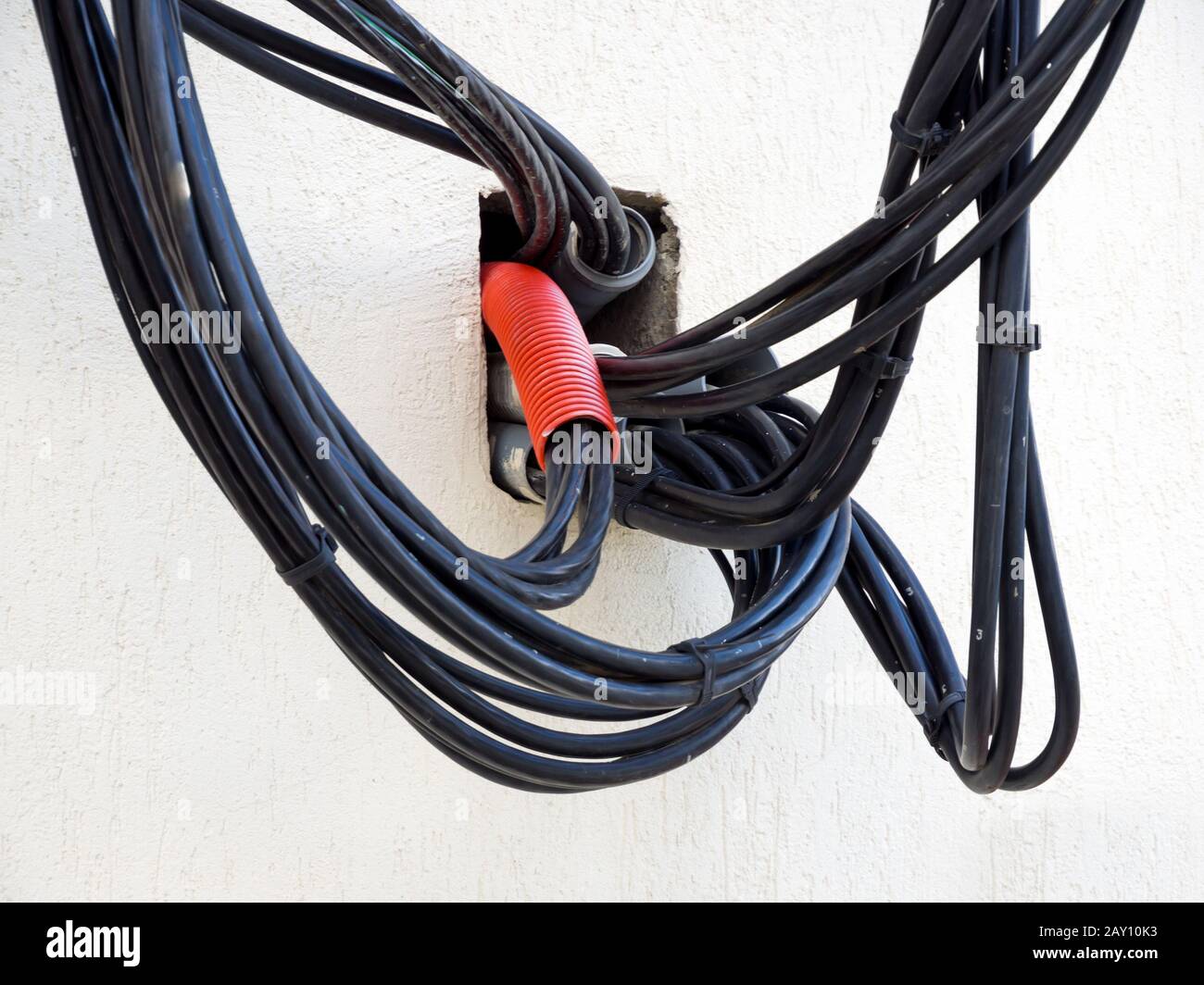 Entering electrical cables into a building wall Stock Photo - Alamy