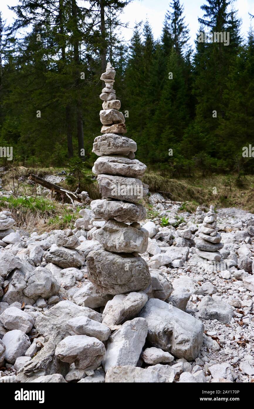 Vertical shot of a stack of rocks in a forest - business stability ...