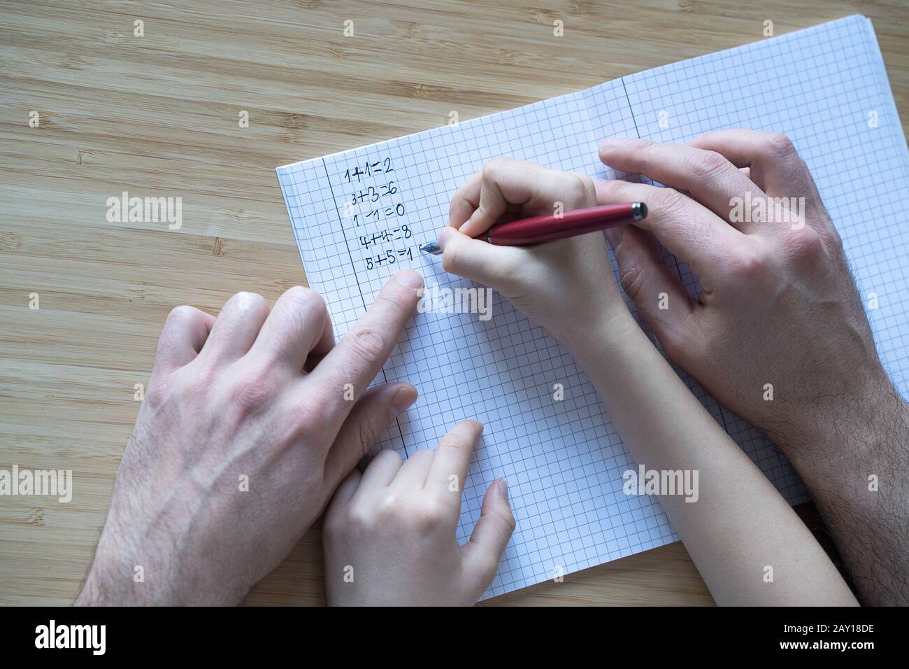 top view of Caucasian adult father helping his child daughter or son ...