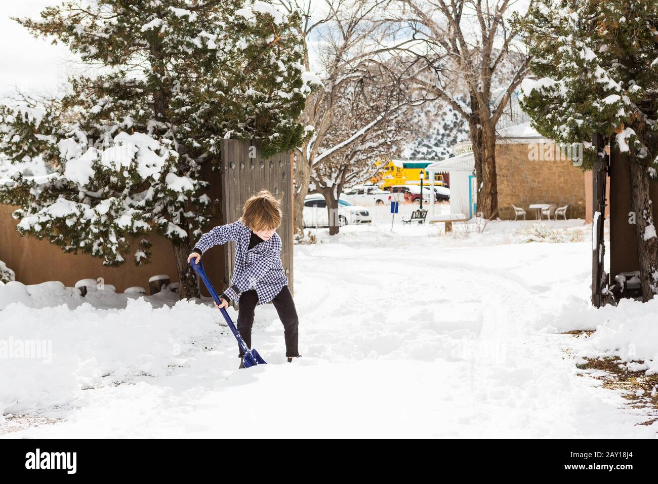 A six year old boy shoveling snow in driveway Stock Photo - Alamy